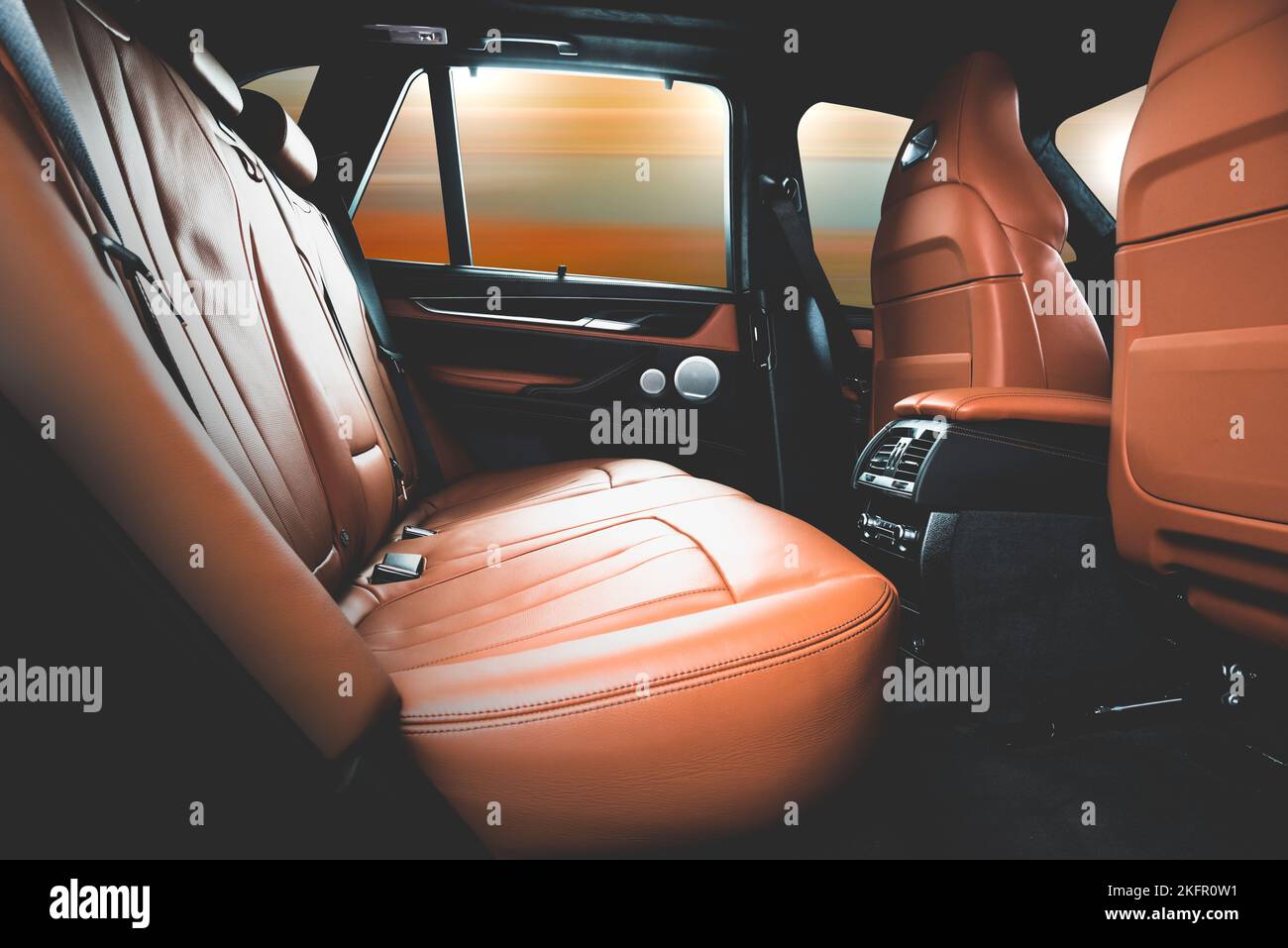 Back passenger seats in modern luxury car, red sand leather Stock Photo ...
