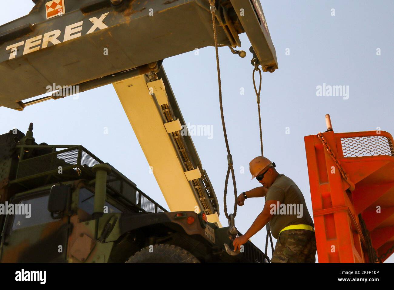 Spc. Andrew Welch of the 35th Infantry Division places crane hooks on ...