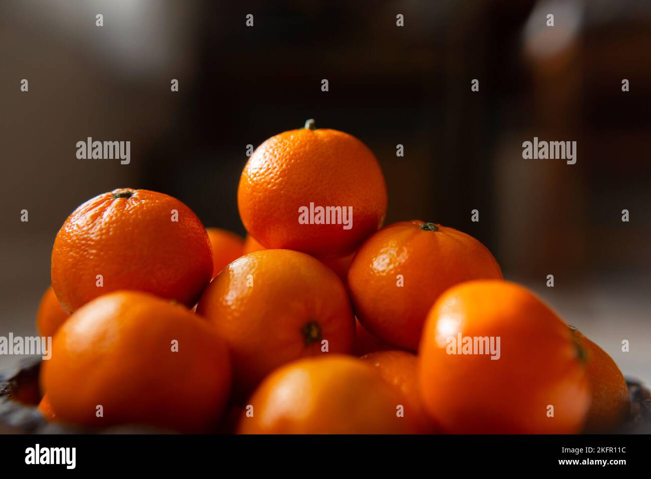 Basket with tangerine or orange fruit on a gray plaid background ...