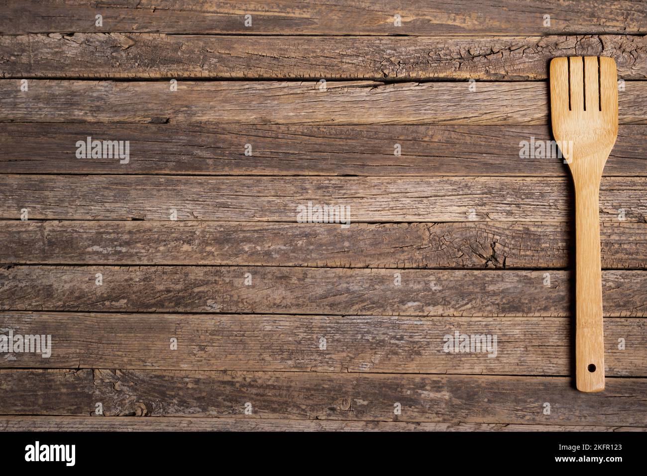 Background of rustic and aged wooden slats with a wooden fork on the ...
