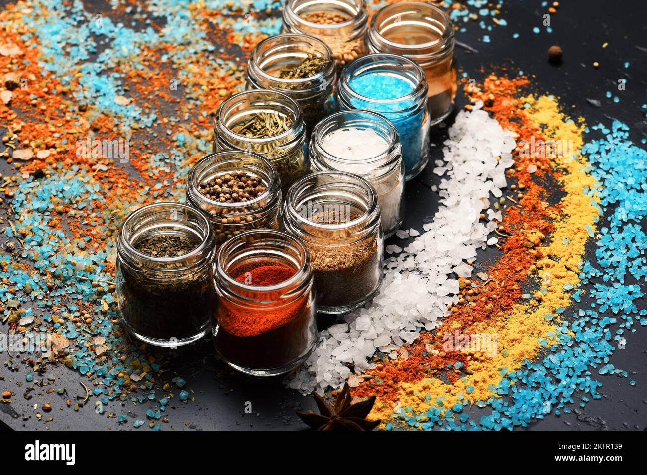 Composition of bottles with colored herbs and spices Stock Photo - Alamy