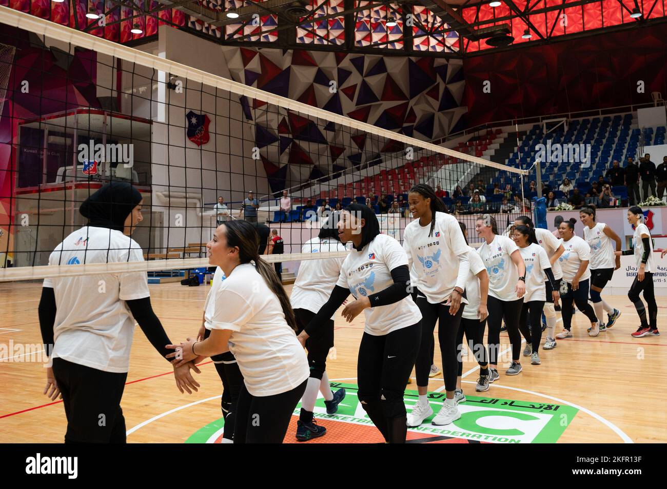 U.S. and Kuwait volleyball players congratulate each other after a game ...