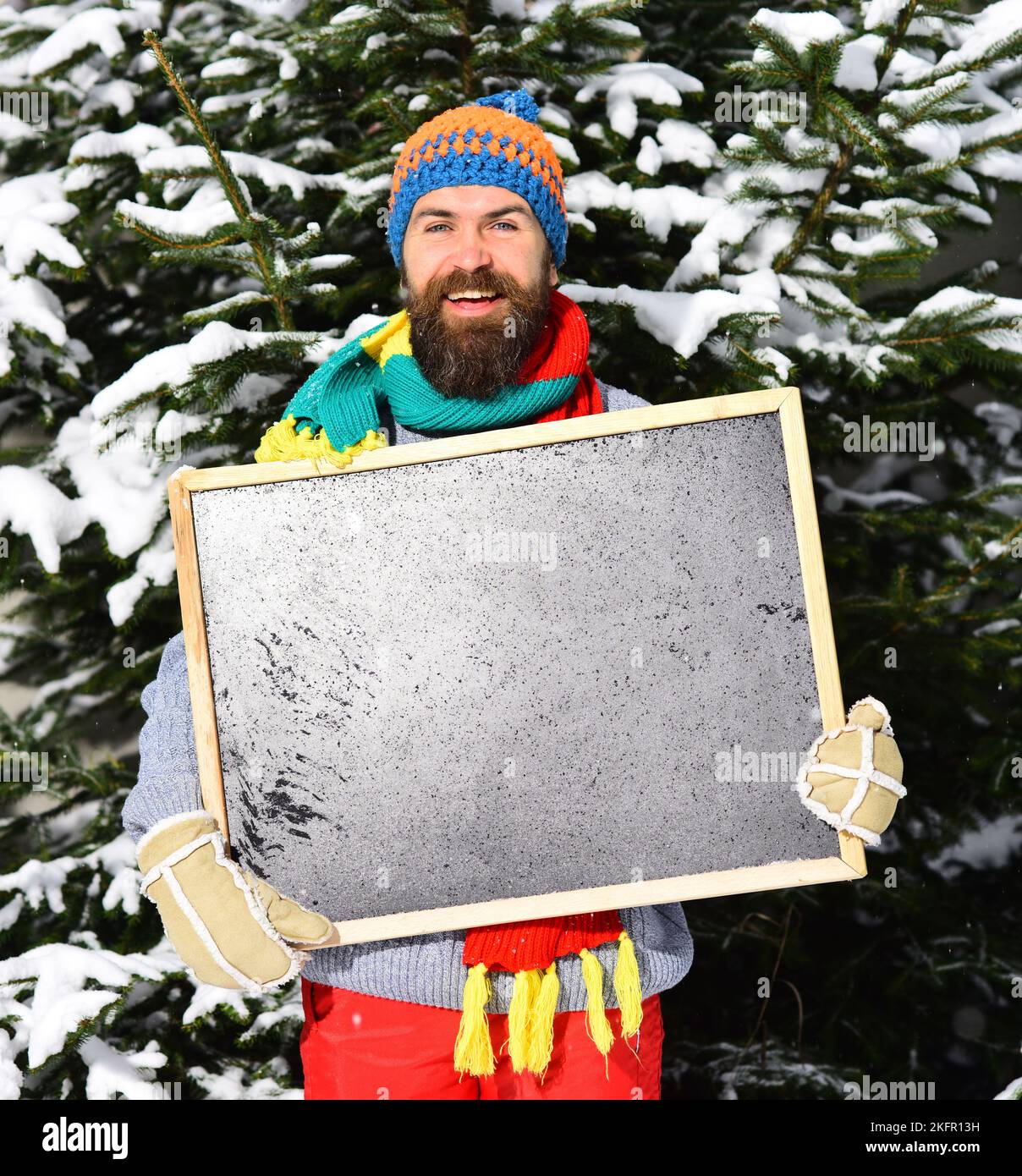 Macho with beard holds chalkboard, copy space Stock Photo - Alamy
