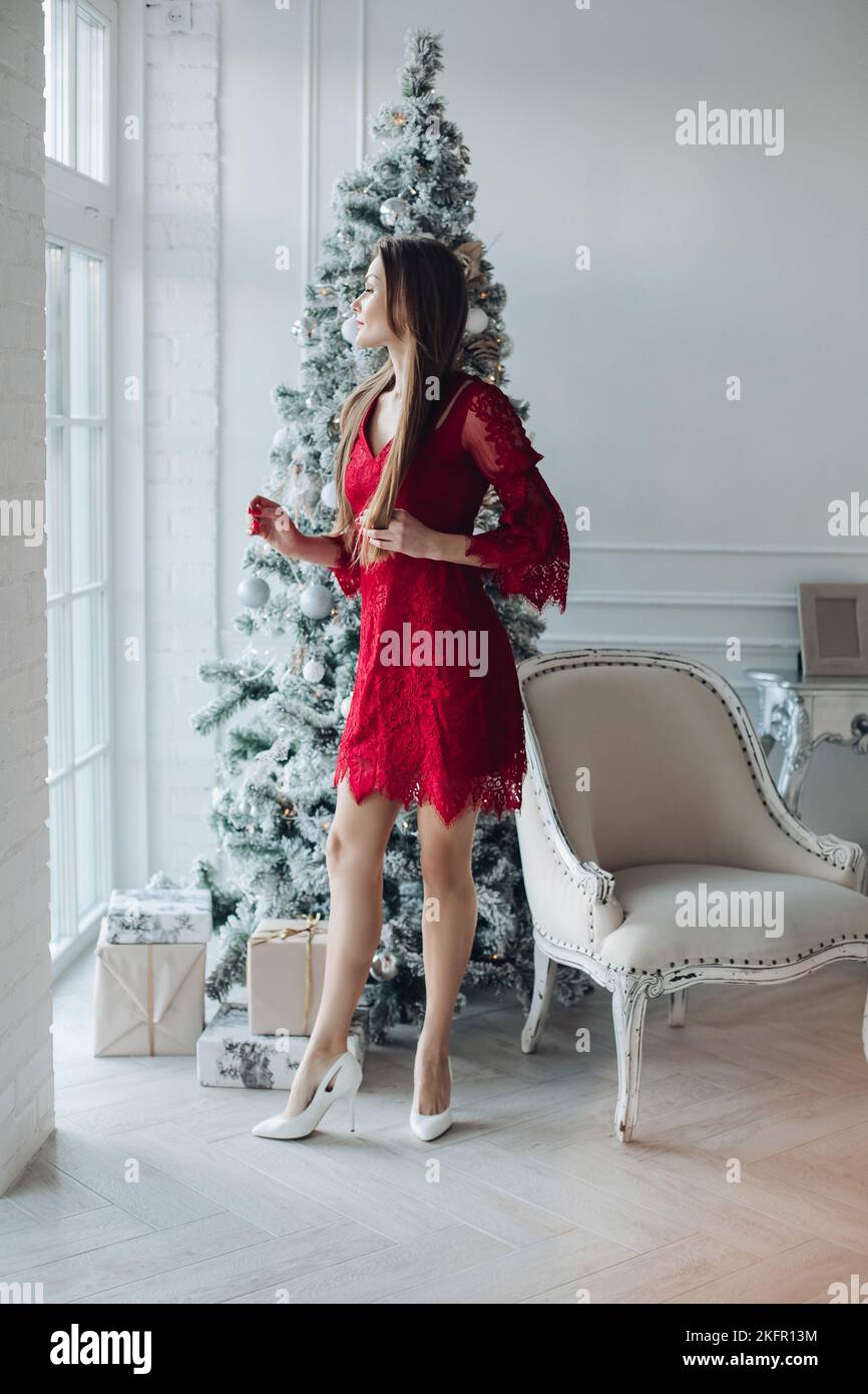 Handsome young woman in red dress smiles Stock Photo - Alamy