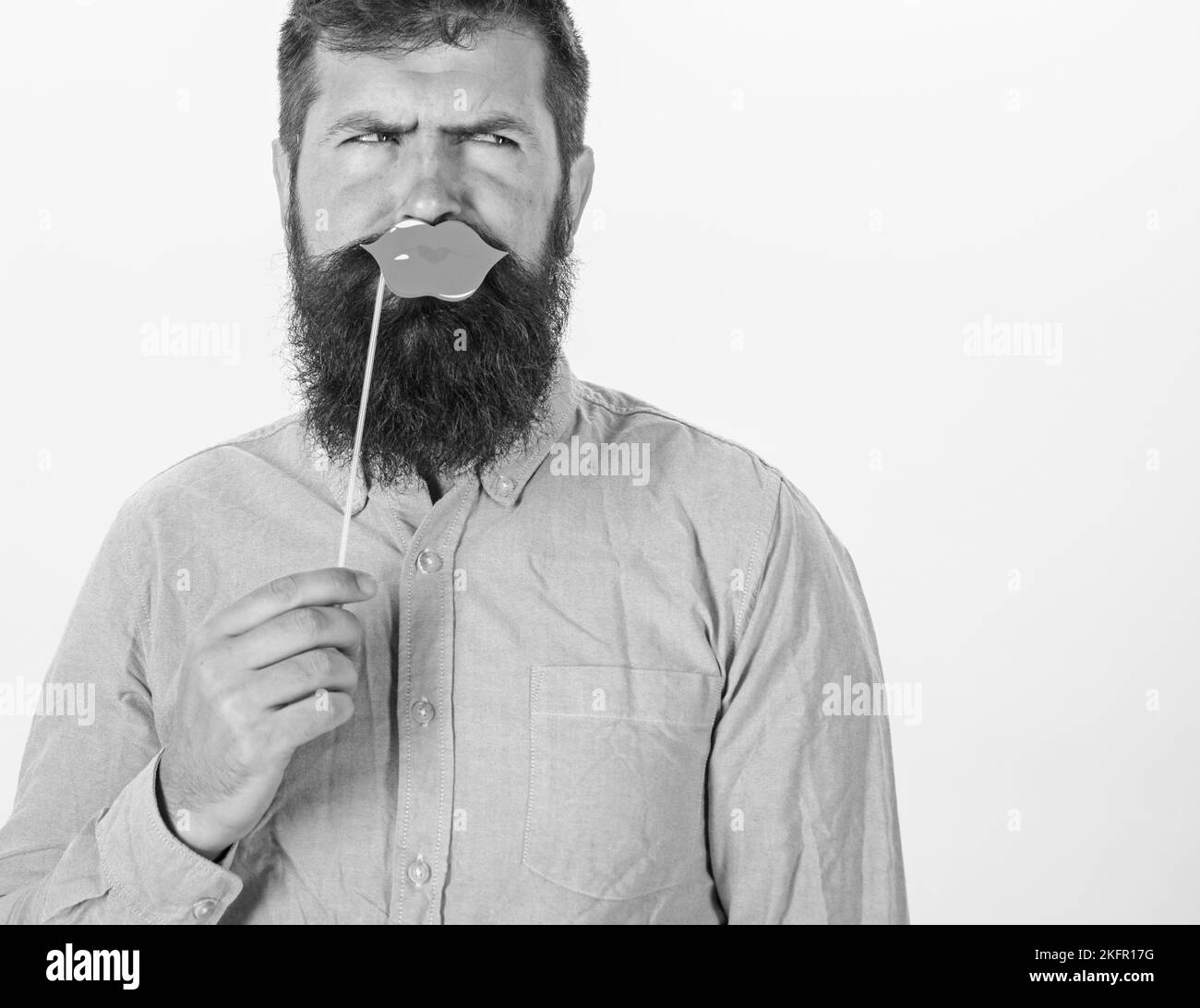 Man with stylish beard holding sensual paper lips. Bearded man in pink ...