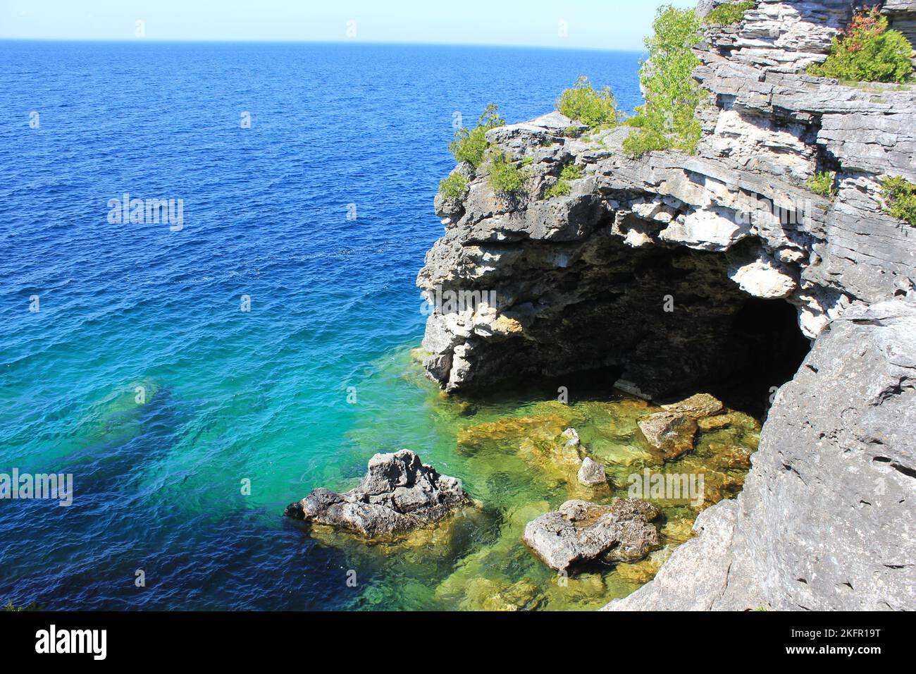A scenic view of the clean sea water under the rocks Stock Photo - Alamy