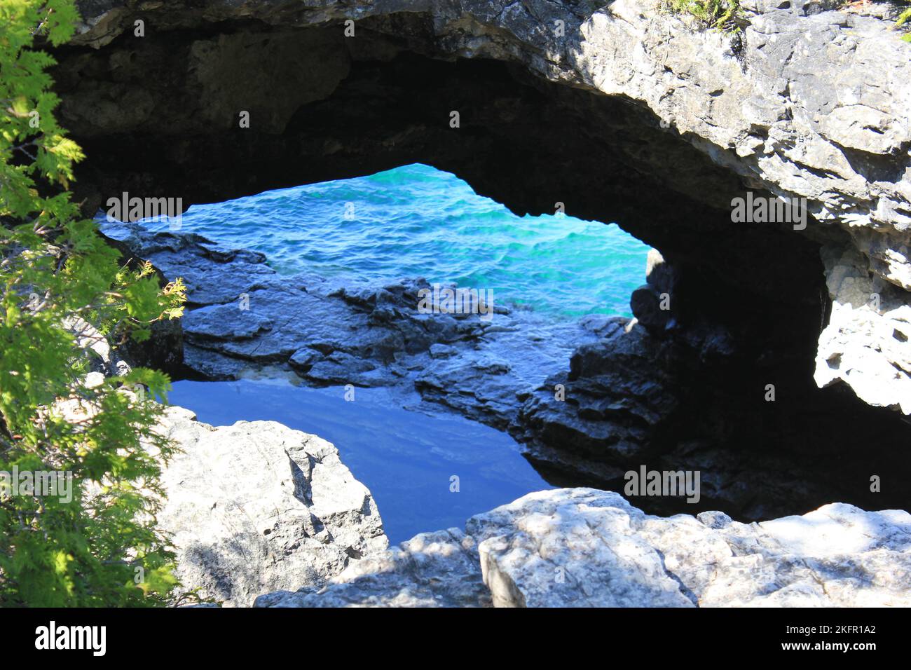 A scenic view of the clean sea water under the rocks Stock Photo - Alamy