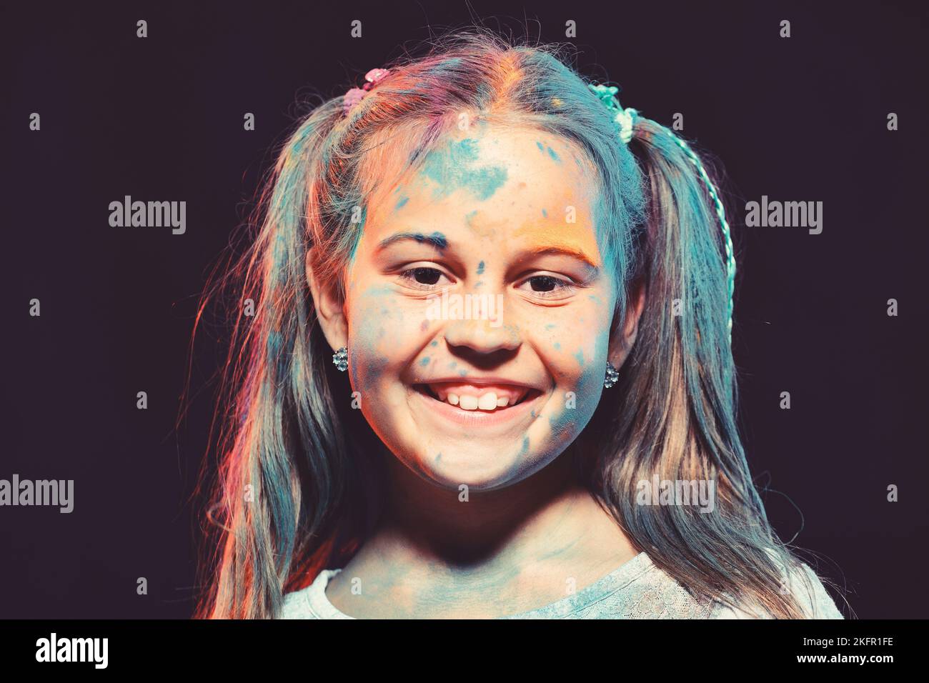 Kid with ponytails colors. Girl with smiling face stands Stock Photo ...