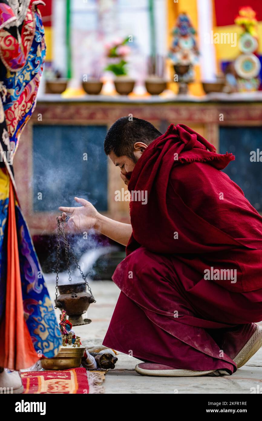 A Tibetan Buddhist worshipers with incense in traditional clothes in ...