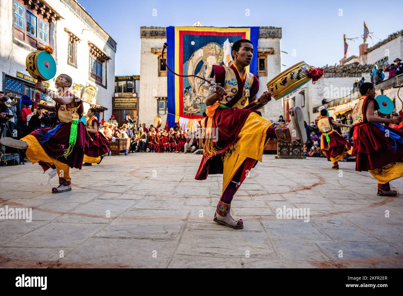 Young Tibetan Buddhists in traditional outfits performing Ritual Dance ...