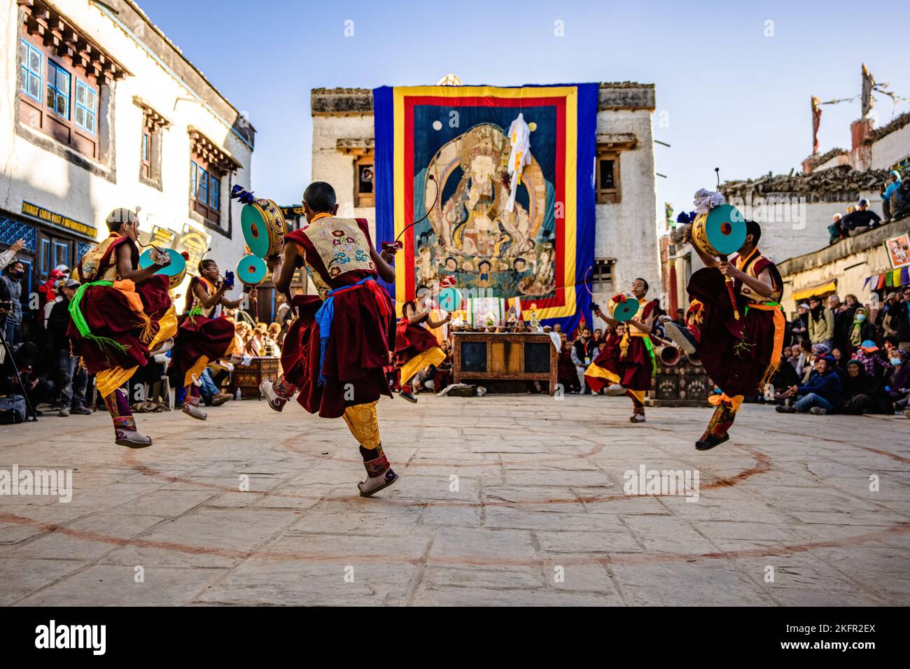 A group of Tibetan Buddhists in traditional clothing outfit performing ...