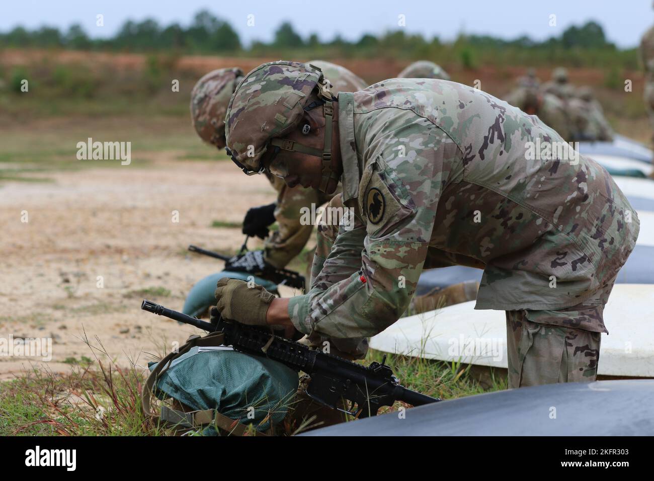 A Soldier of Squad 7, United States Army Reserves, makes adjustments to ...