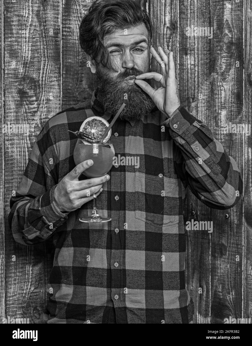Man shows delicious gesture on wooden texture background Stock Photo ...