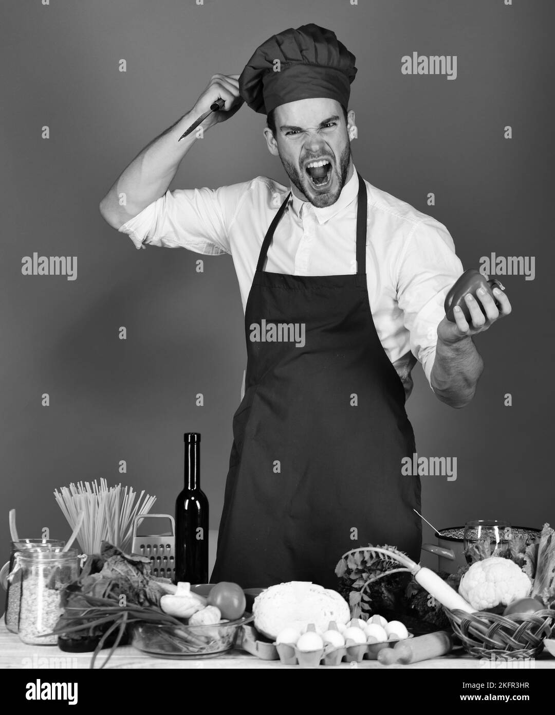 Cook works in kitchen near vegetables and tools Stock Photo - Alamy