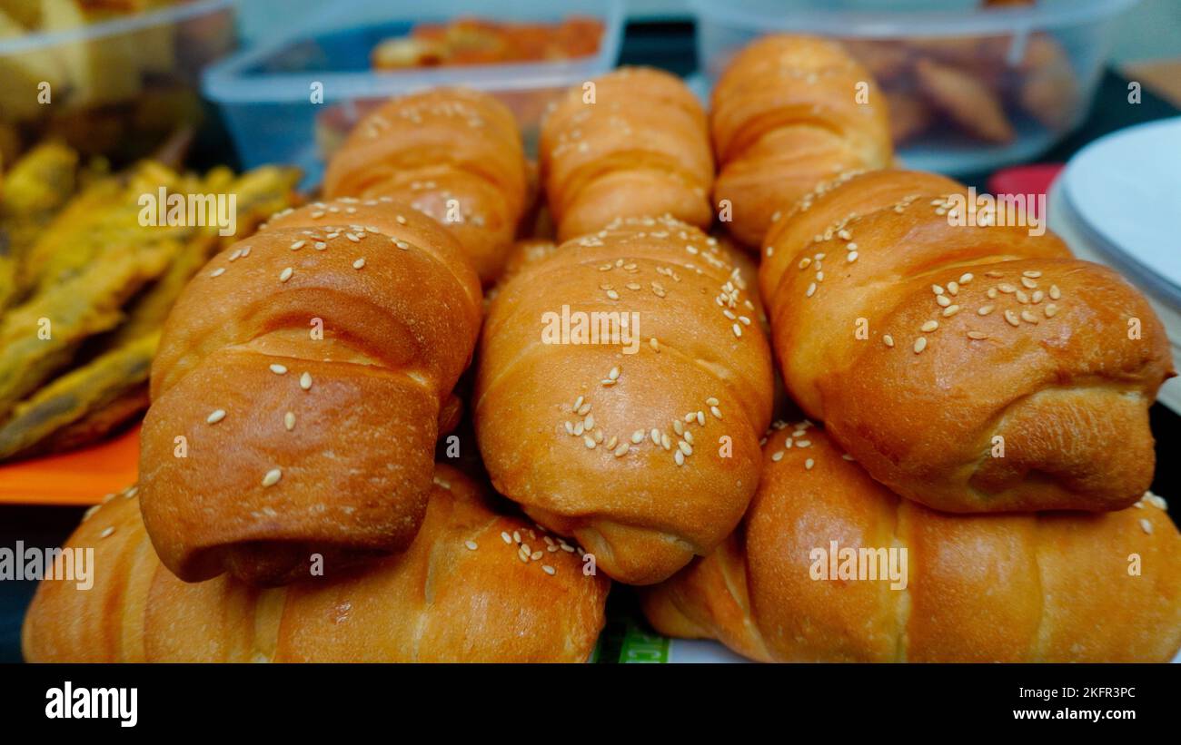 A closeup shot of freshly baked sausage buns at a bakery Stock Photo ...