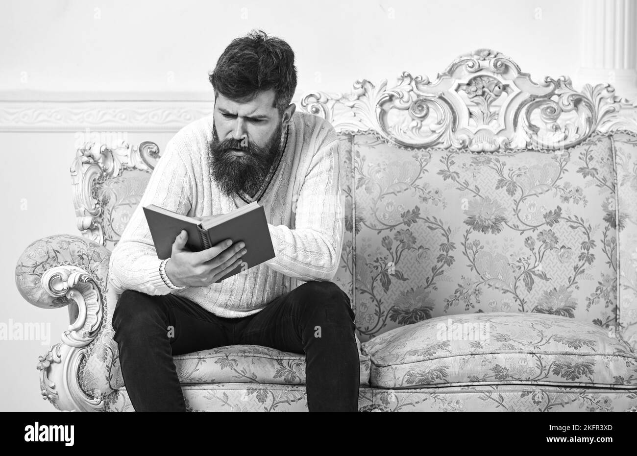 Macho on concentrated face reading book. Scandalous bestseller concept ...