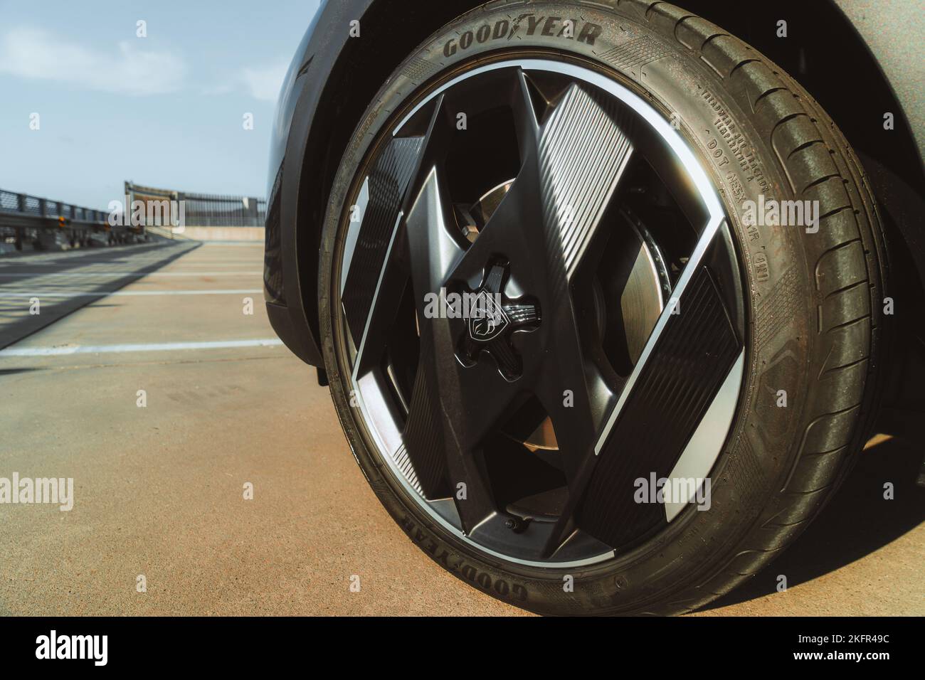 A closeup shot of one of the wheels of the new Peugeot 408 hybrid under ...