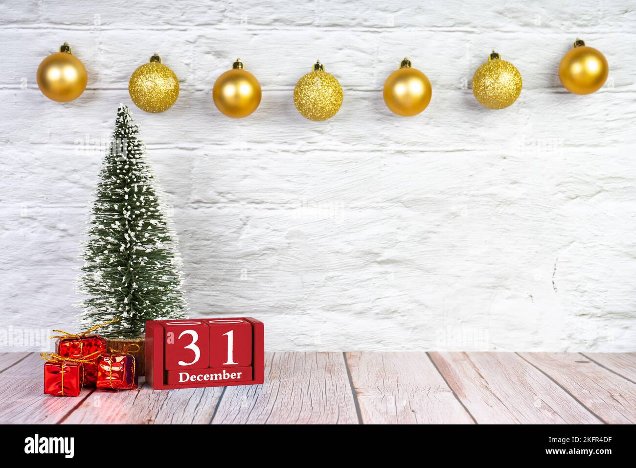 Decorative Christmas tree, gift boxes and red wooden perpetual calendar ...