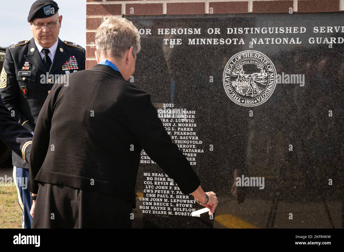 Sgt. (Ret.) Diane M. Buszta removes the cover from her name inscribed ...