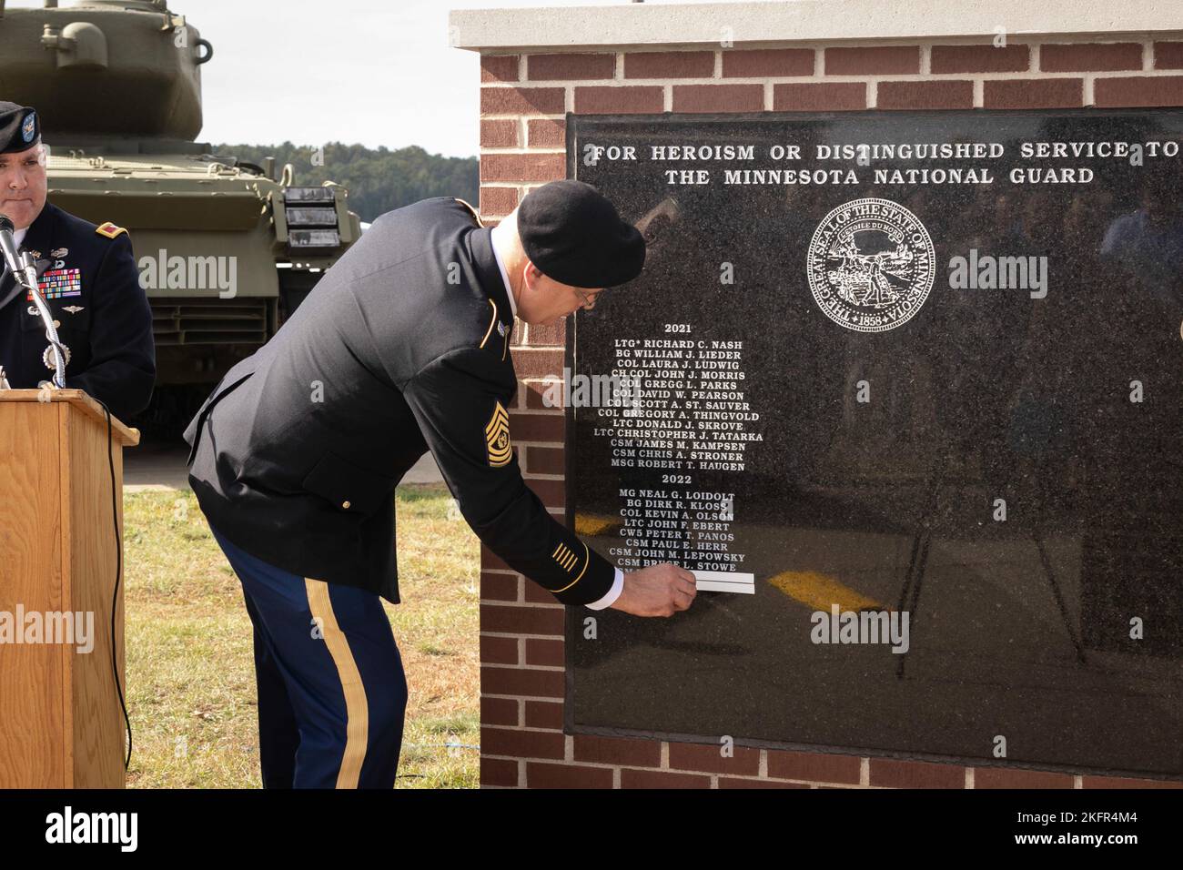 Minnesota’s Army Command Sgt. Maj. George Jensen removes the cover from ...