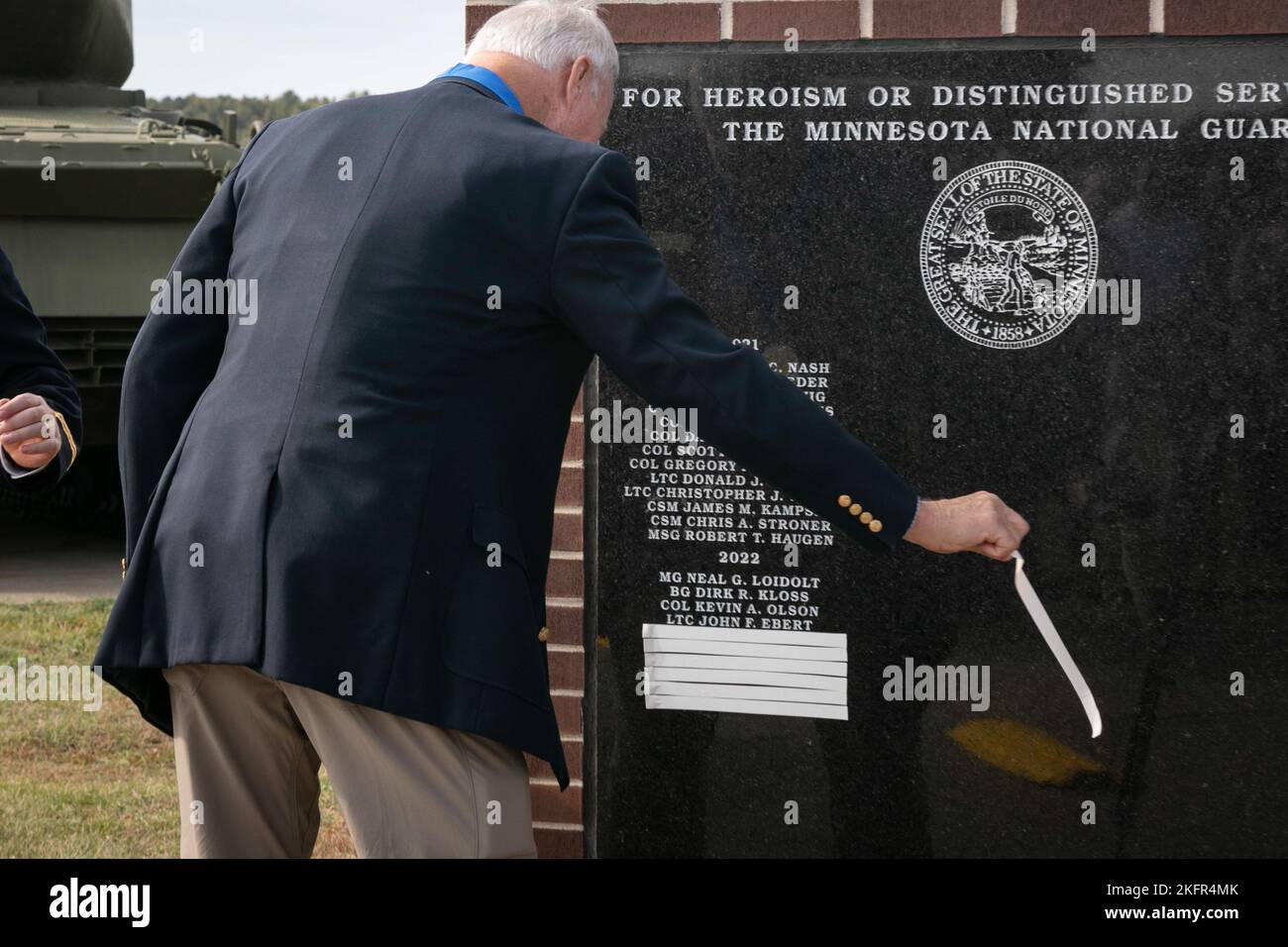 Lt. Col. (Ret.) John F. Ebert removes the cover from his name inscribed ...
