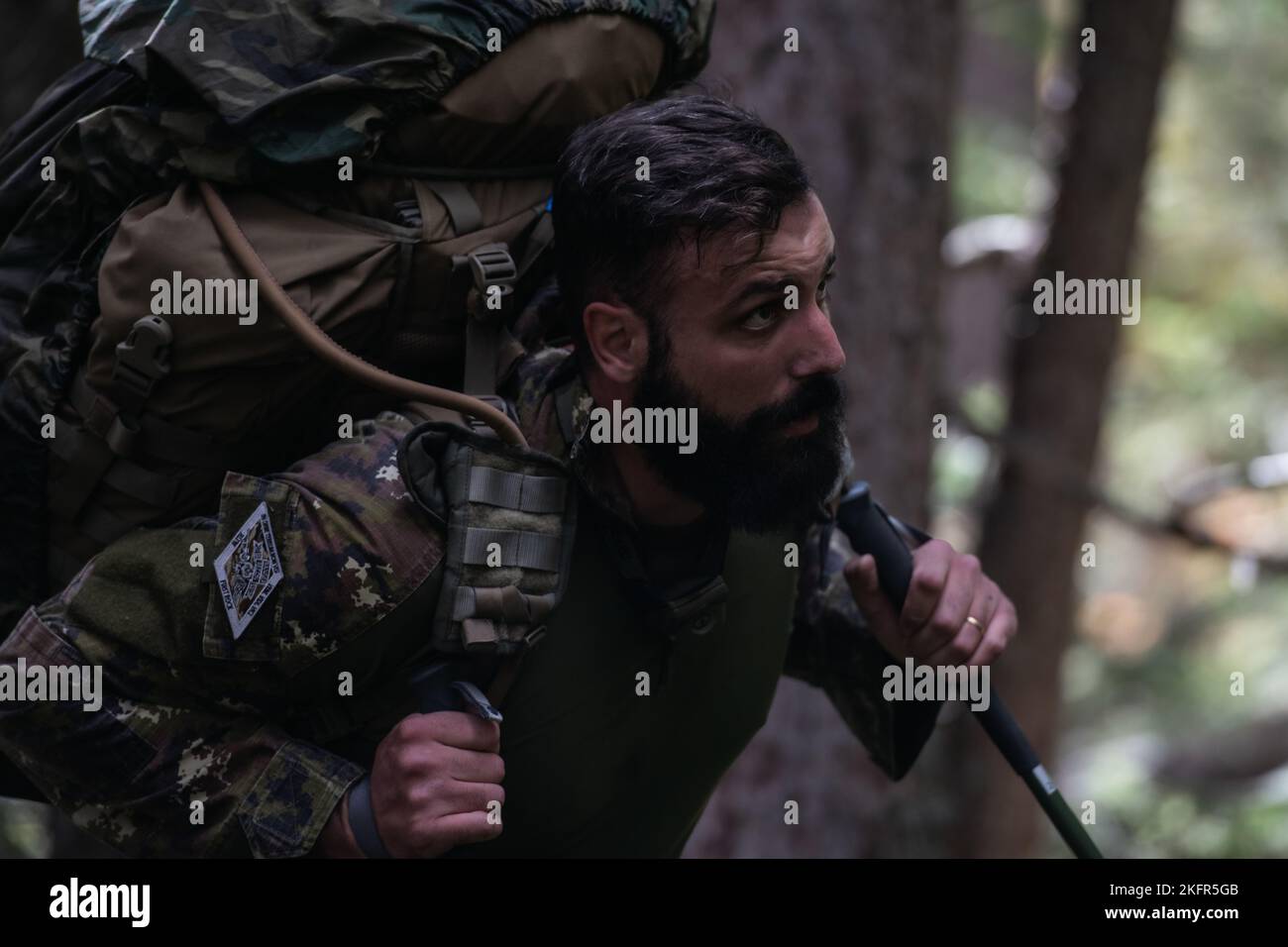 An Italian Army soldier with the Alpini Brigade moves up a mountain alongside U.S. Army ...