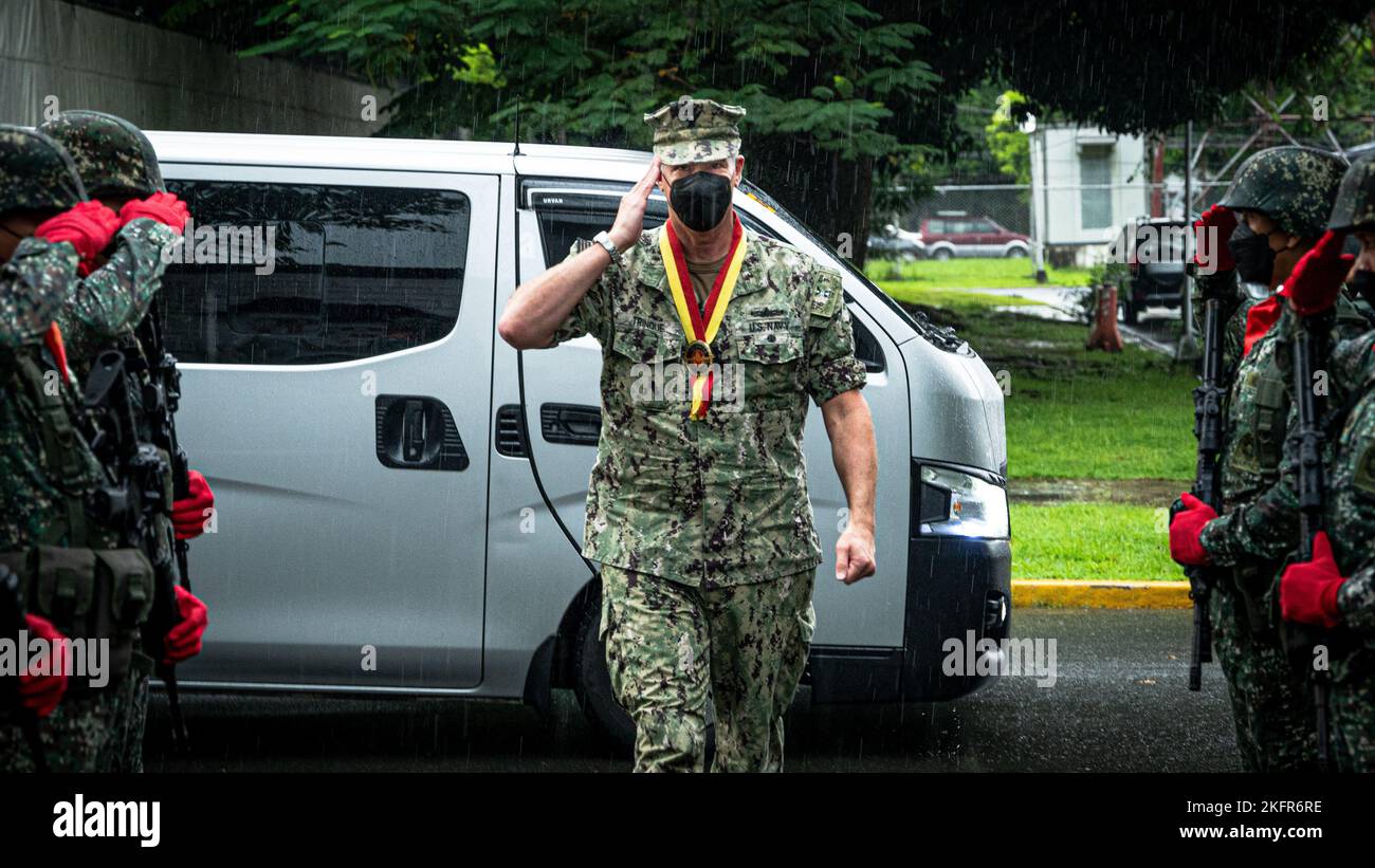 U.S. Navy Rear Adm. Derek Trinque, commander, Task Force 76/3, receives ...