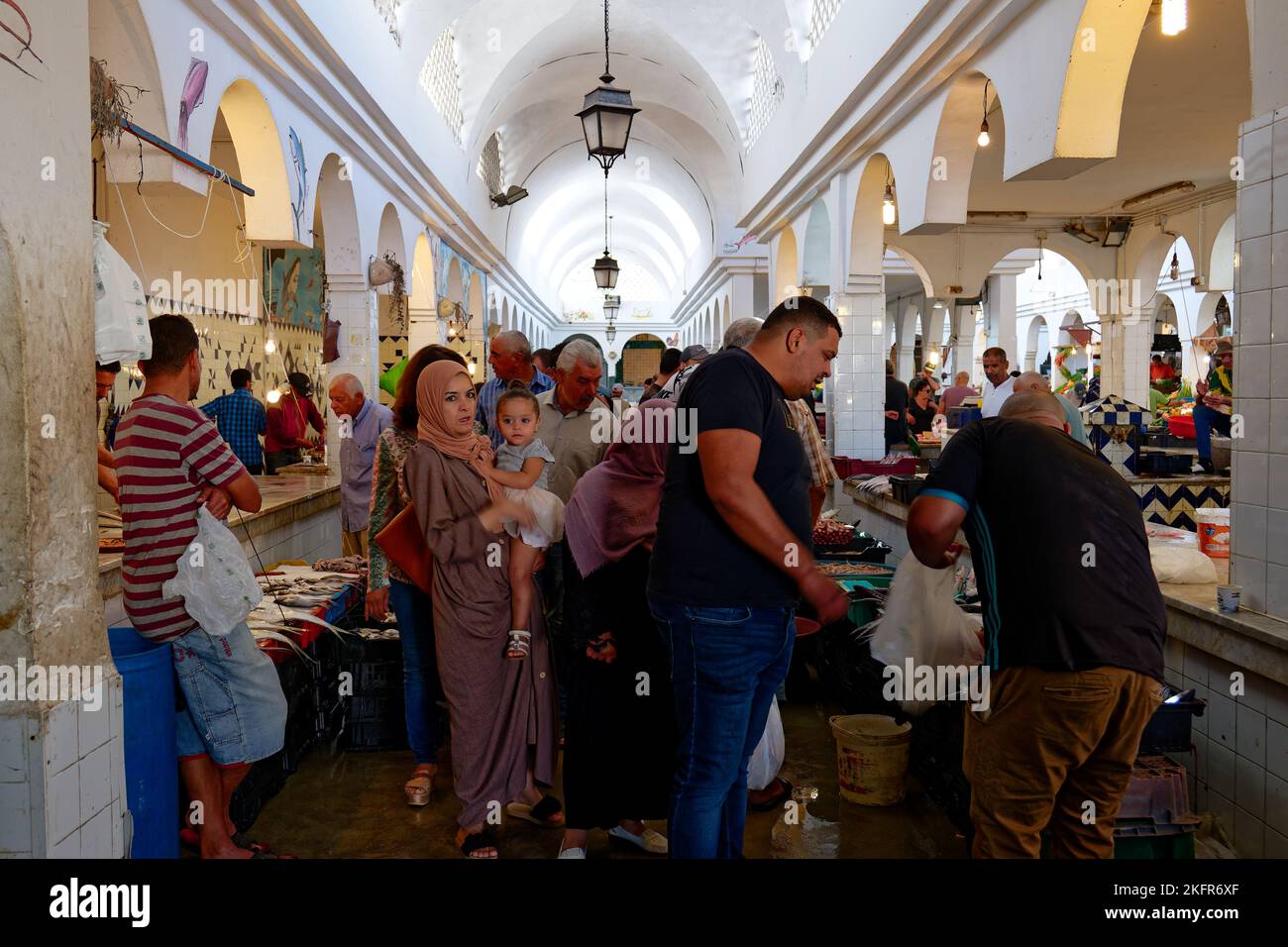 Fish market in the old city of Medina of Sousse. Group of people ...