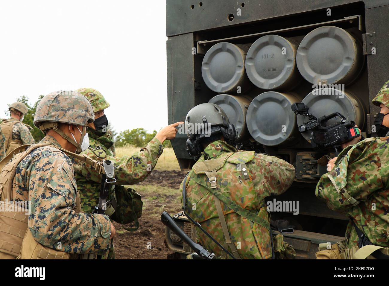 U.S. Marines with 12th Marine Regiment, 3d Marine Division, observe ...