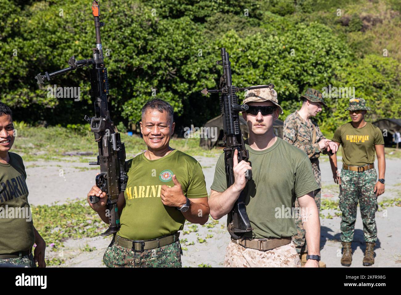 A Philippine Marine and U.S. Marine Corps Lance Cpl. Cameron Roof, a ...