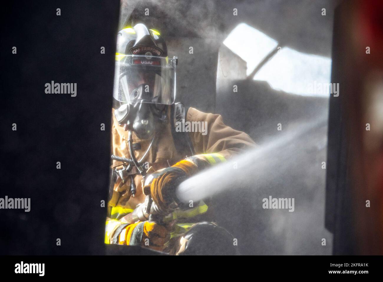 A firefighter from the 422d Fire Emergency Services extinguishes an ...