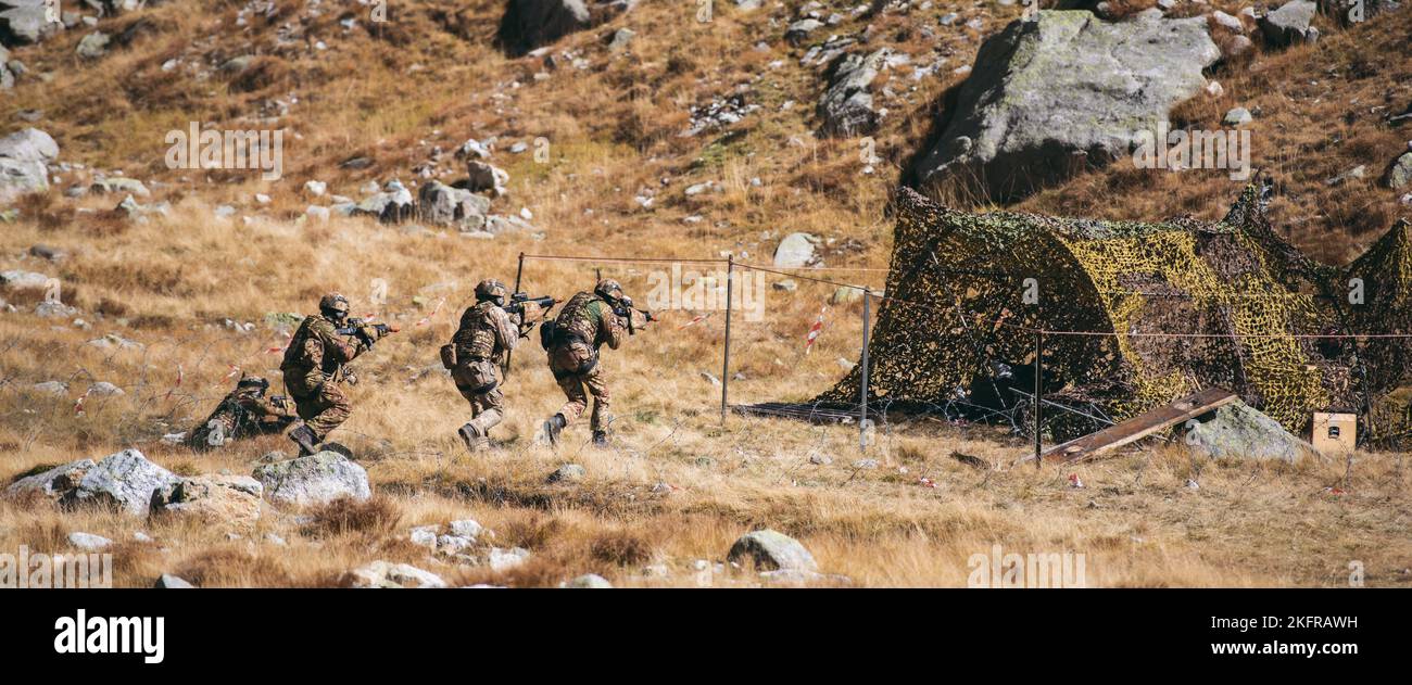 Italian Army soldiers with the Alpini Brigade assault an opposing forces position during a blank ...