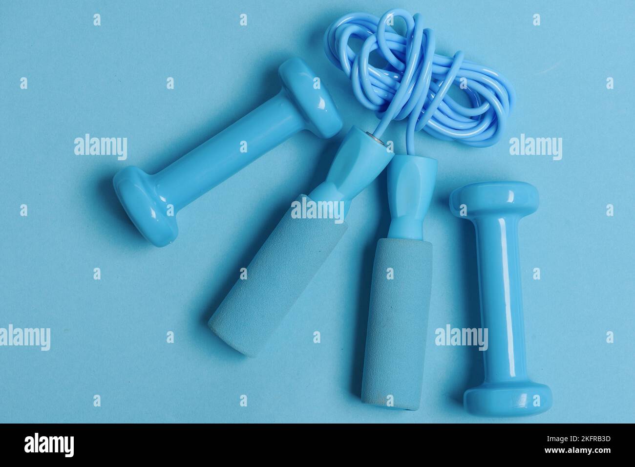 Jump rope and barbells placed next to each other Stock Photo - Alamy