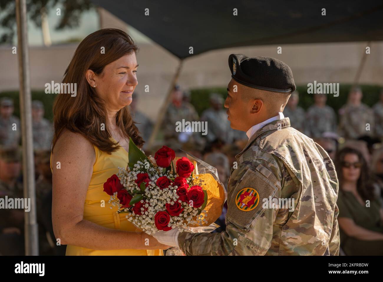 Emma White, wife of Lt. Gen Robert "Pat" White, is presented with red ...