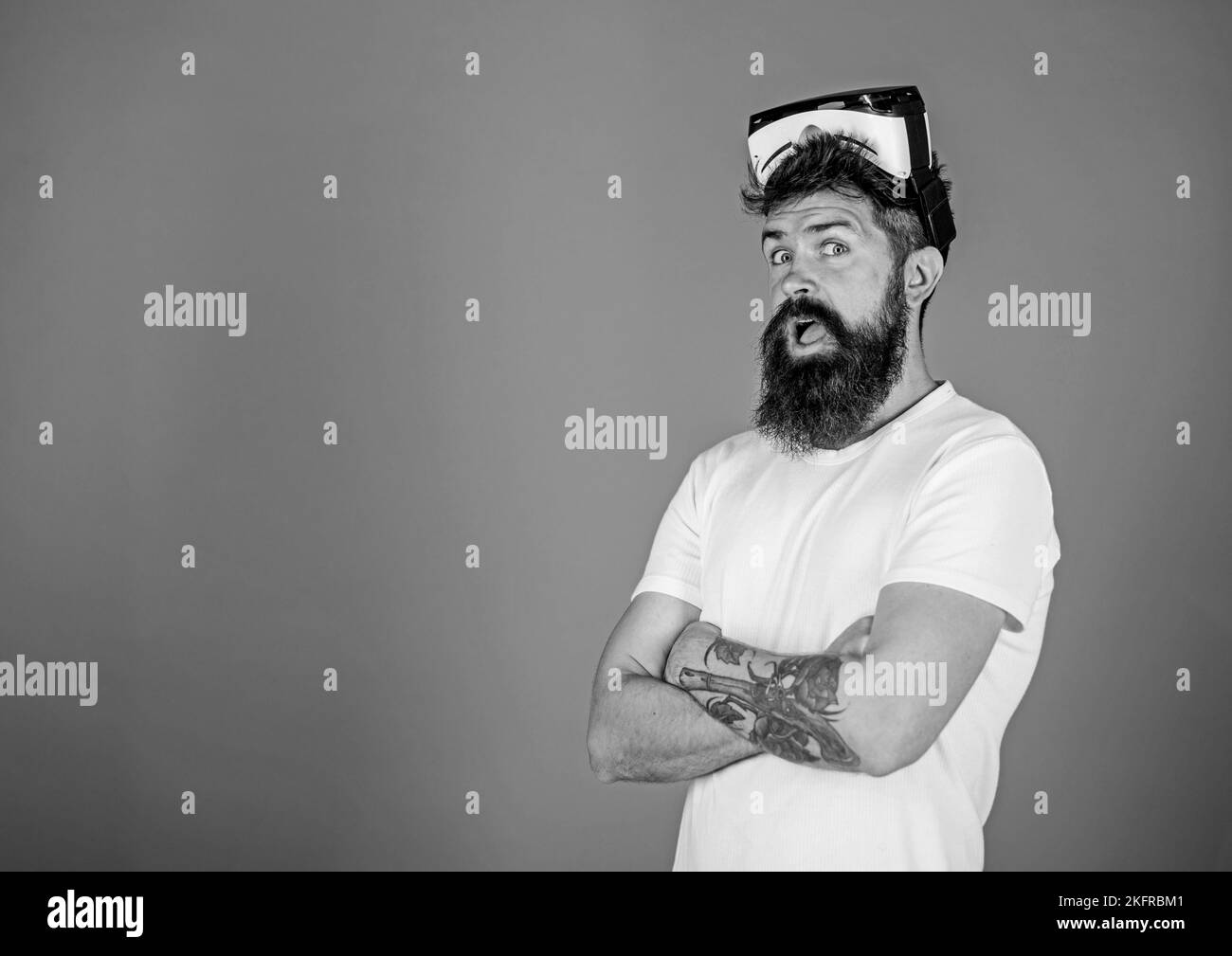 Man with beard and mustache with VR glasses, blue background. Guy with ...