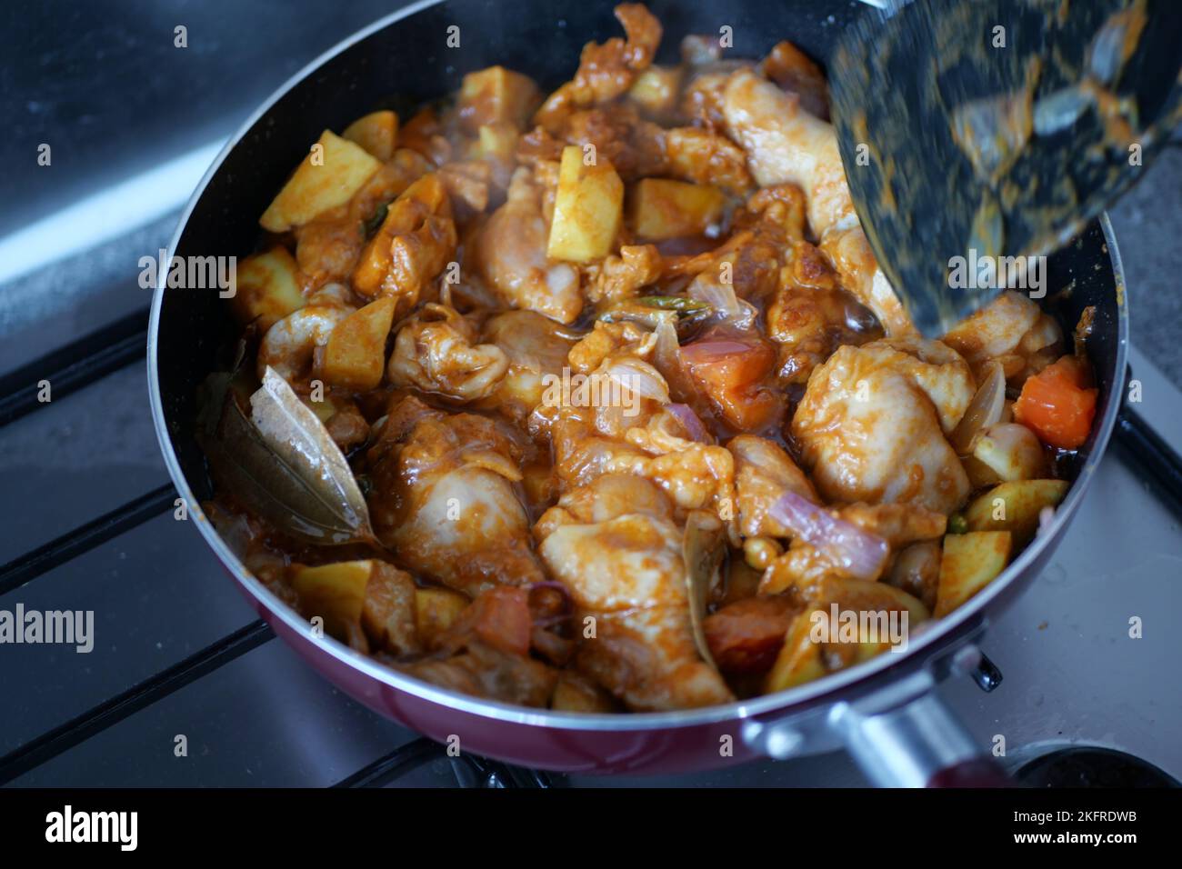 cooking chicken curry in a cooking pan Stock Photo - Alamy