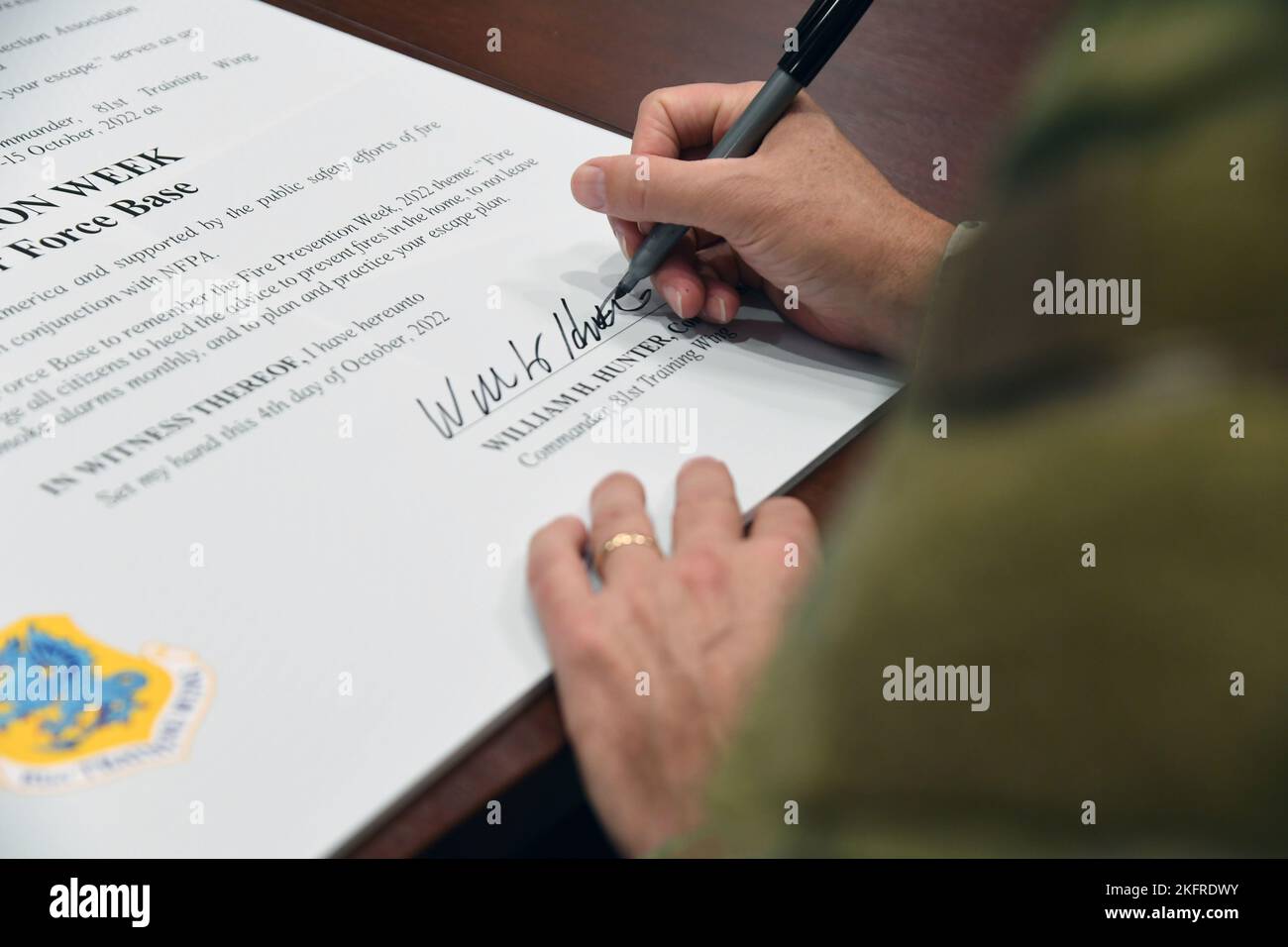 U.S. Air Force Col. William Hunter, 81st Training Wing commander, signs ...
