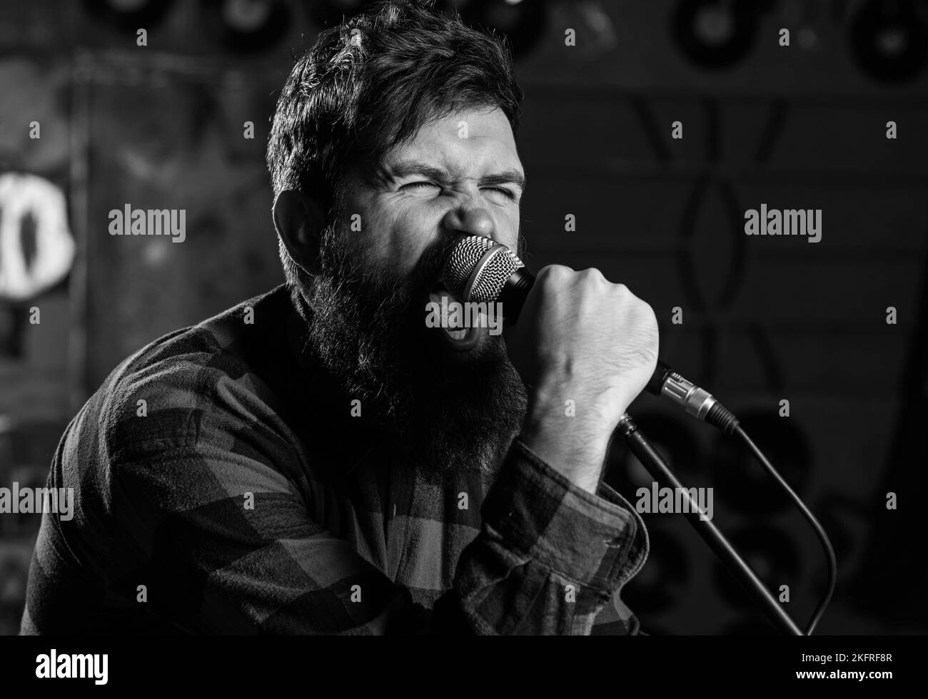 Musician with beard and mustache singing song in karaoke. Rock star ...