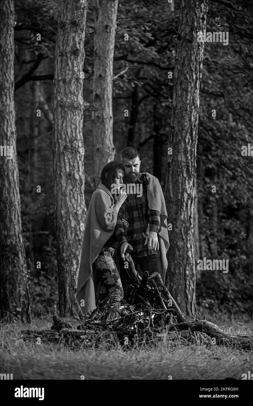 Man with woman hugs and warming up near bonfire Stock Photo - Alamy