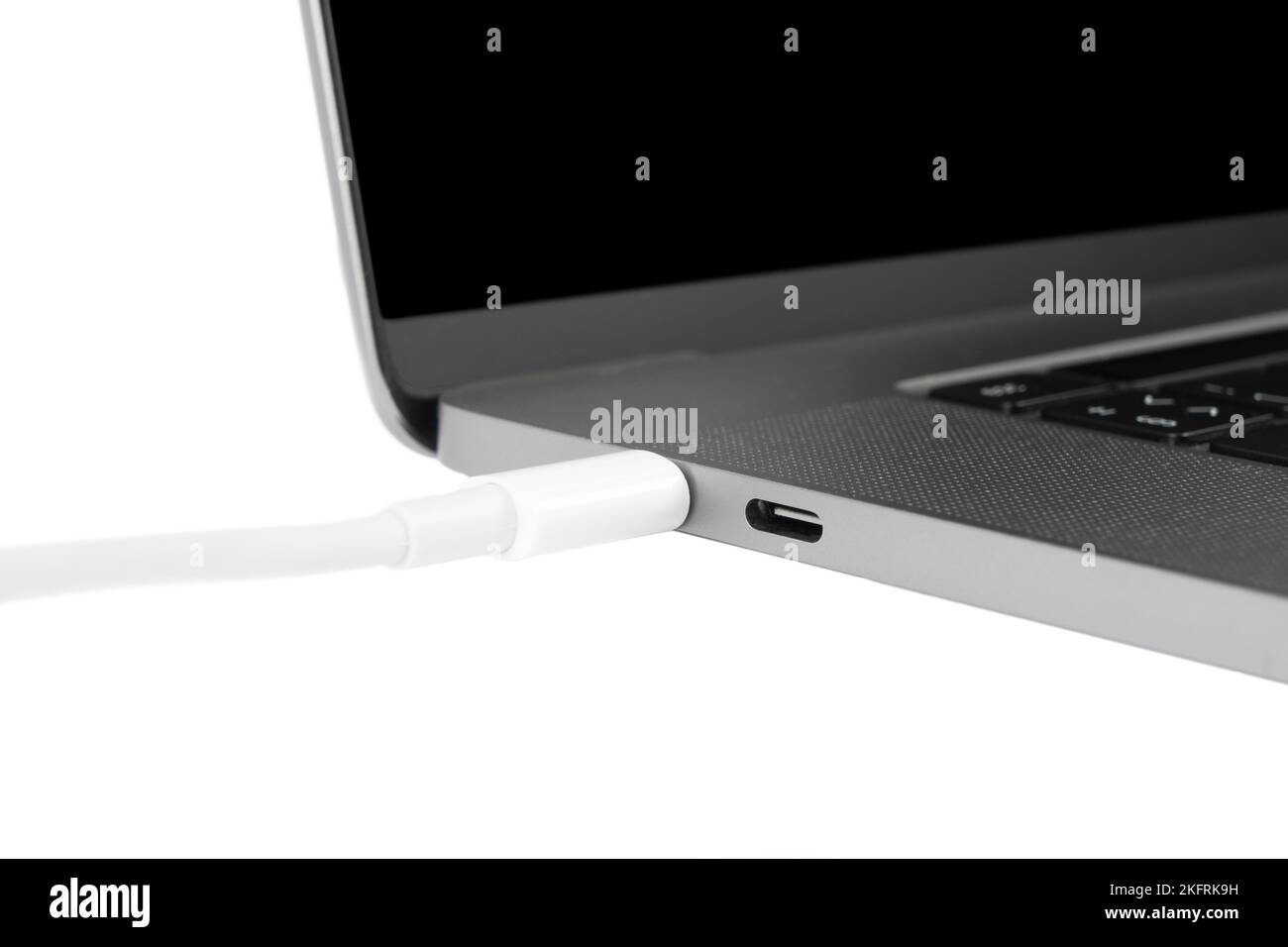 Modern laptop and charging cable isolated on white background. Laptop ...