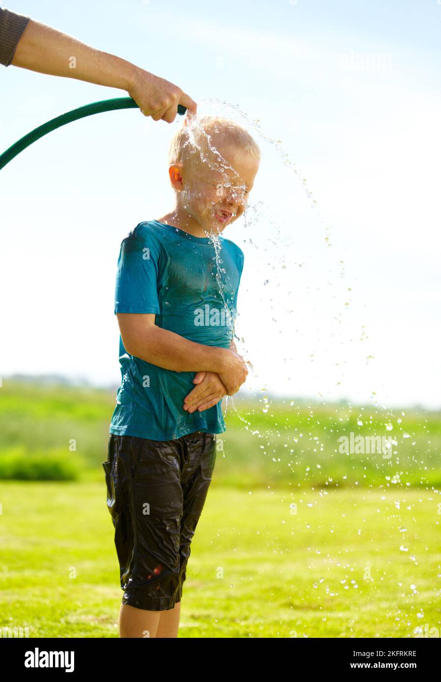 They dont need a pool to cool off. Little boys getting wet by a hose ...
