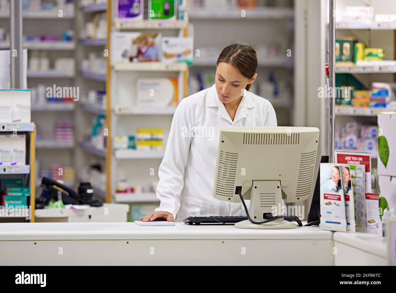 Tracking your prescription. an attractive young pharmacist working at ...