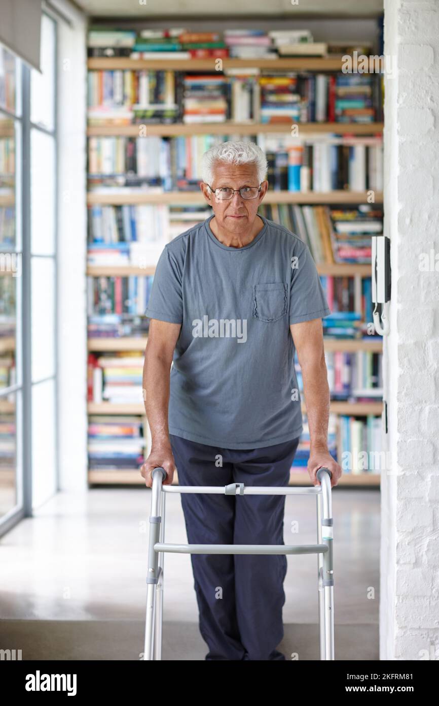 On the move with the help of a walker. Portrait of a senior man ...
