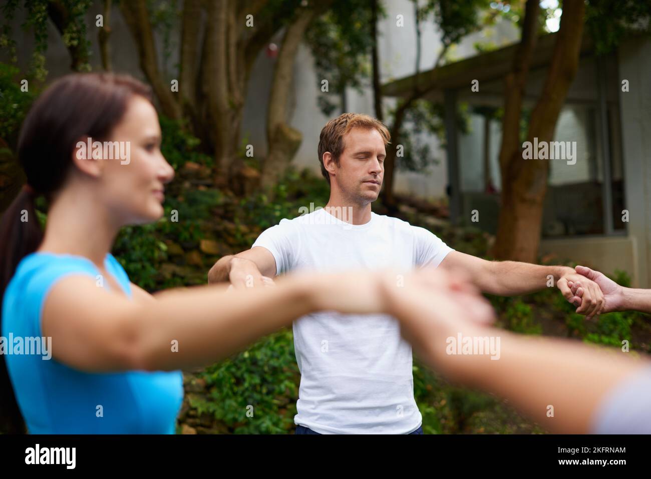 Learning to meditate together. people standing outside meditating in a ...