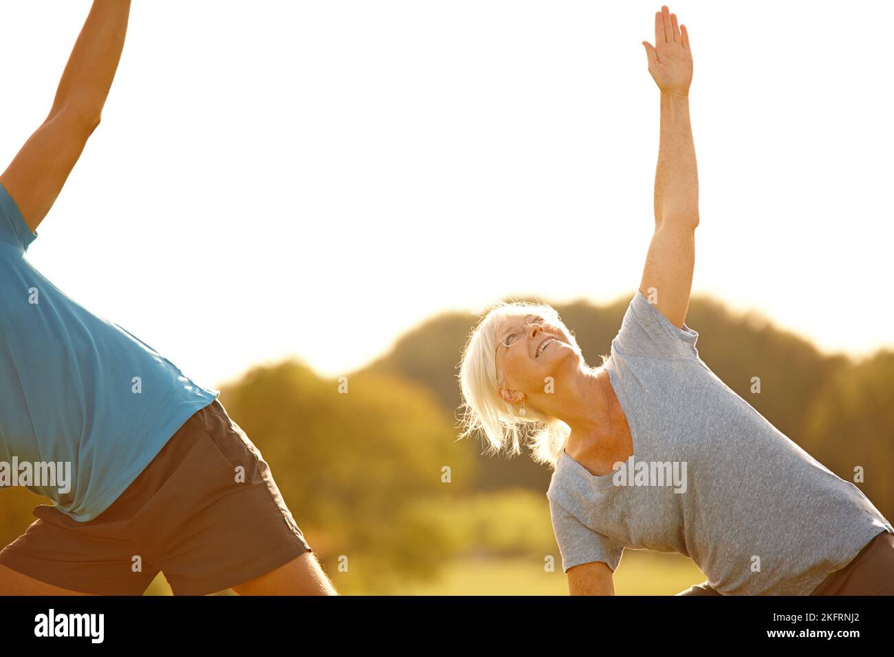Taking good care of her body. a mature couple doing yoga together ...