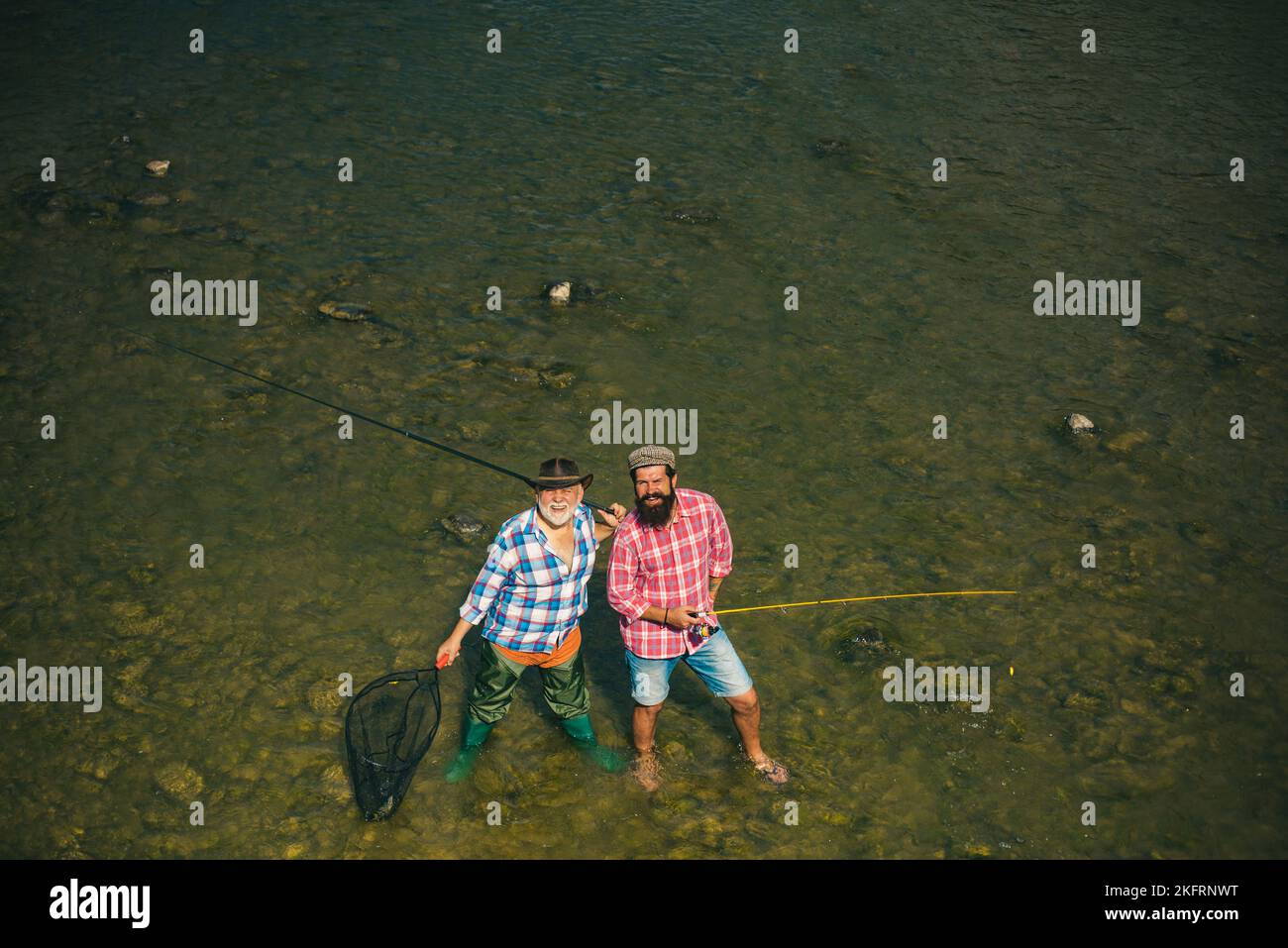 Mature senior man with friend fishing. Summer vacation. Happy cheerful ...