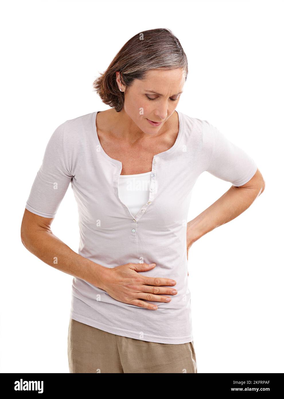 Stomach pain and discomfort. Studio shot of a mature woman experiencing ...