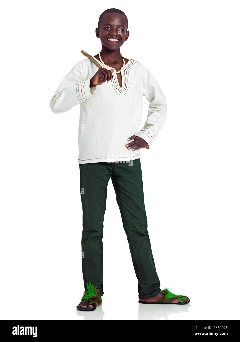 In touch with my heritage. Full length studio portrait of a young african teenage boy isolated ...