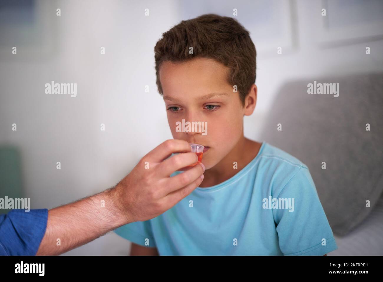 This will help with the pain. a caring father giving his sick little ...