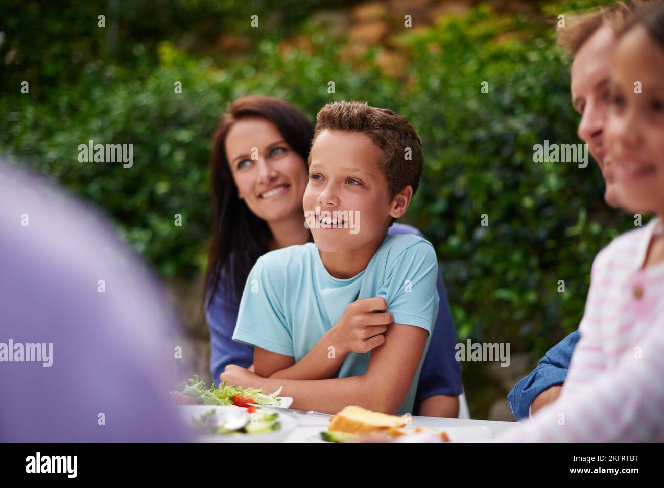 Family and laughter. a happy multi-generational family having a meal ...